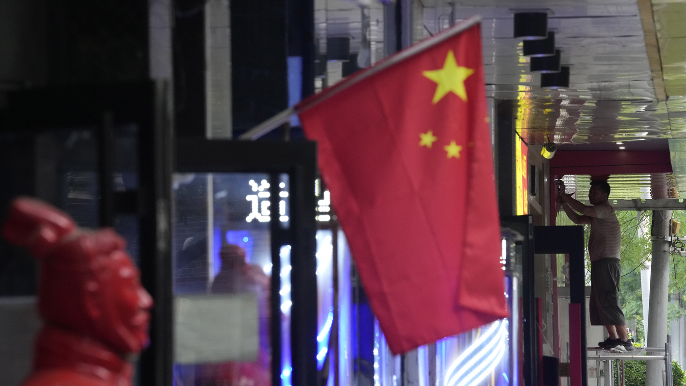 China backs away from growth goal, sticks to virus controls : NPR