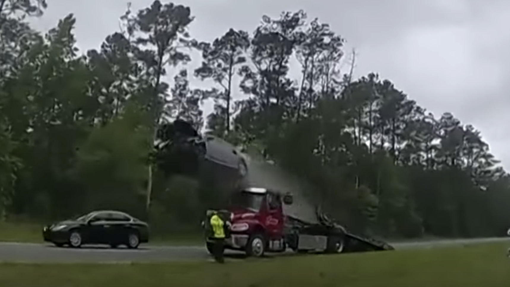 A driver's car soared 120 feet after vaulting off of a tow truck's ramp ...