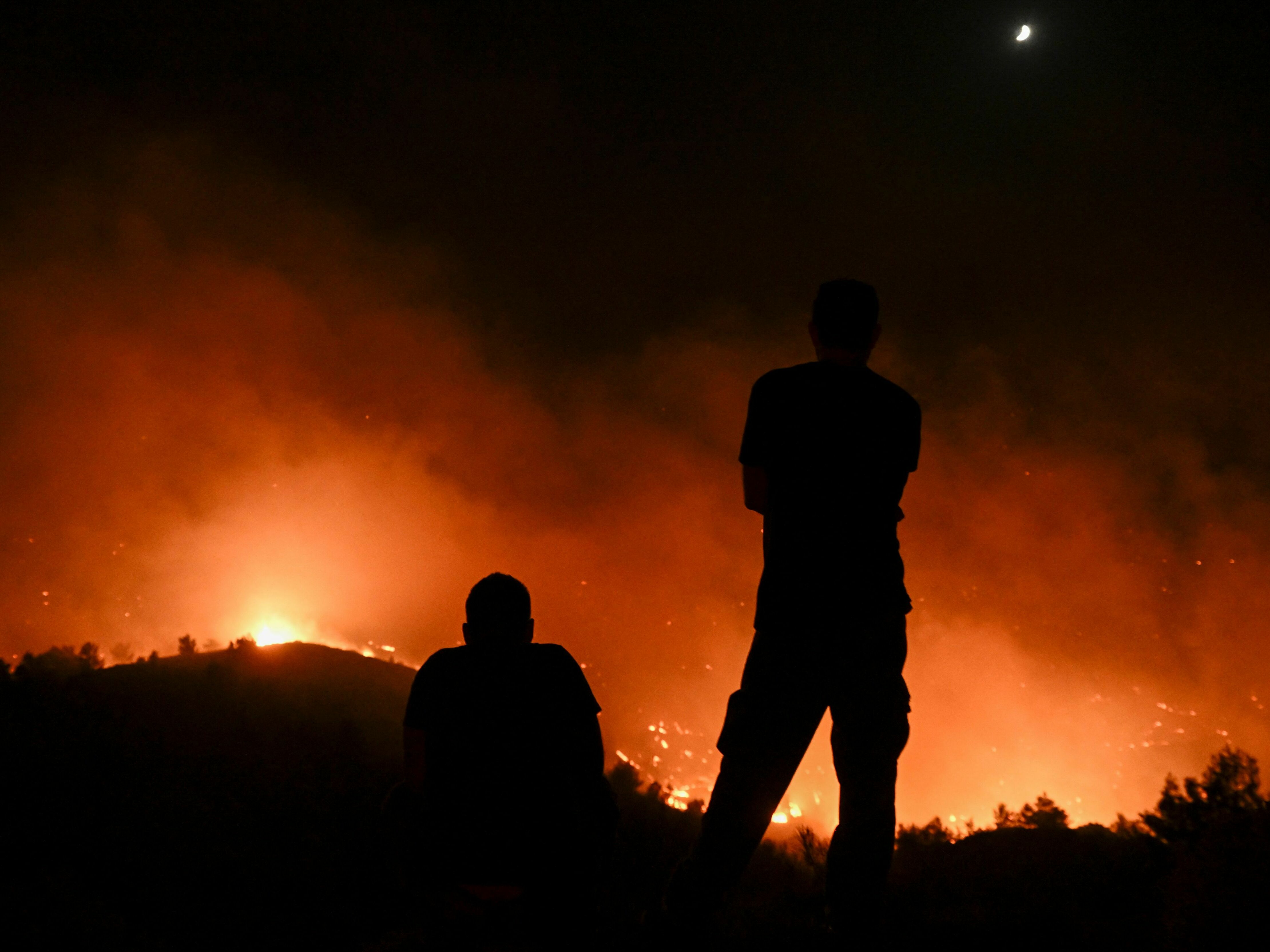 Wildfires in Greece prompt massive evacuations, leaving tourists in ...