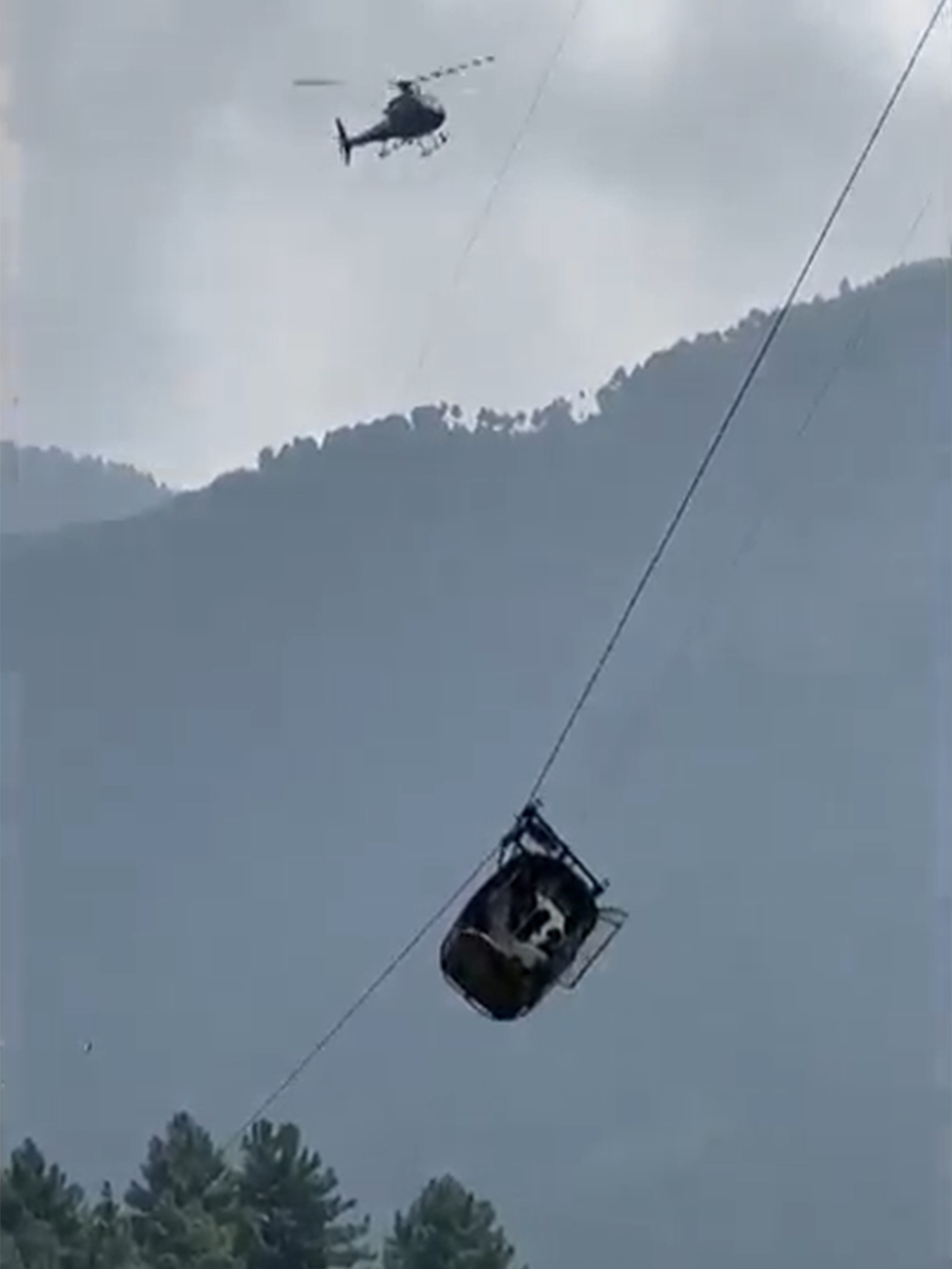 Pakistan rescue mission underway to save 8 people trapped in a danglng cable car : NPR